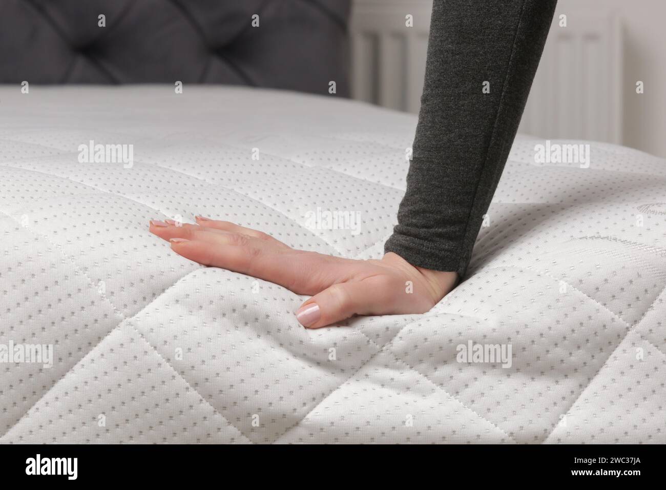Woman checking mattress hi-res stock photography and images - Alamy