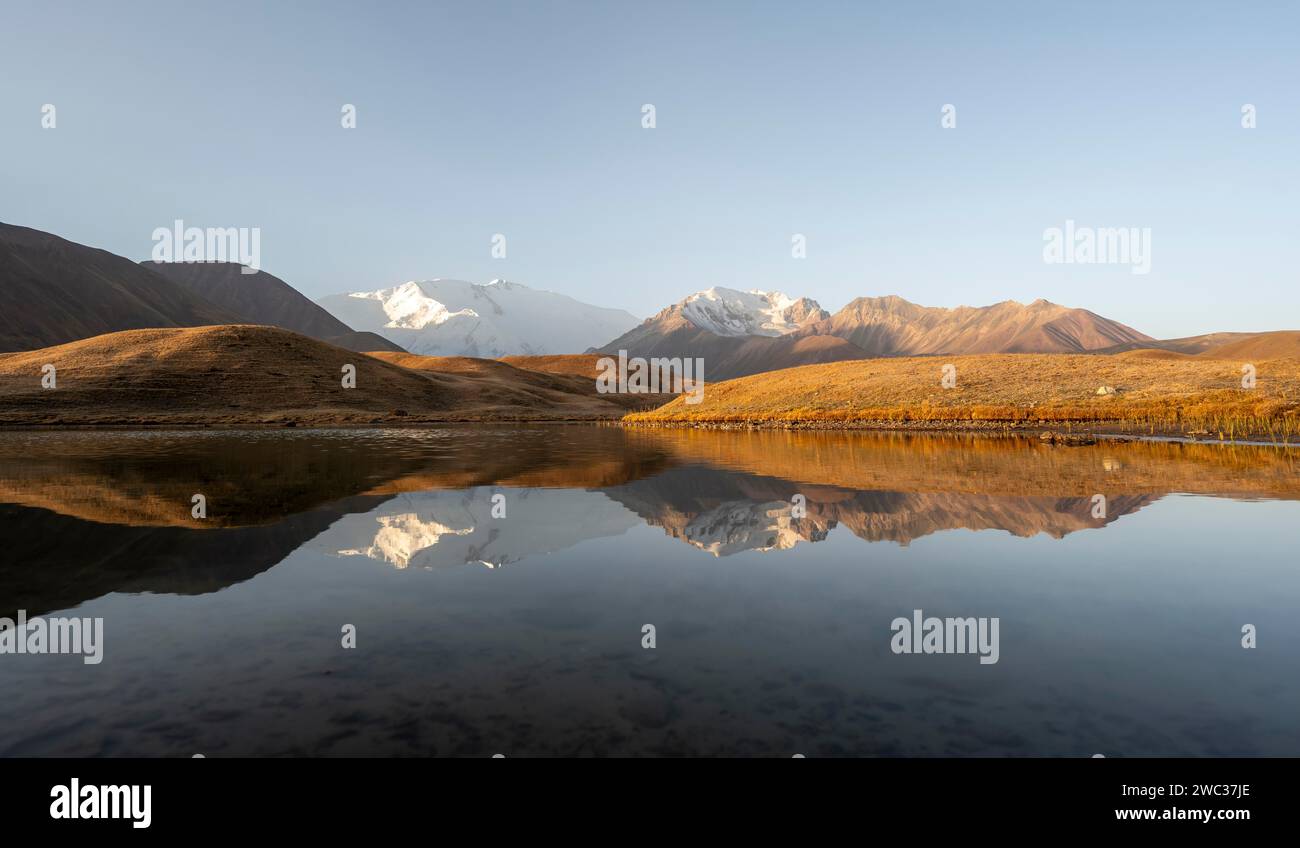 White glaciated and snowy mountain peak Pik Lenin at sunrise, mountains ...