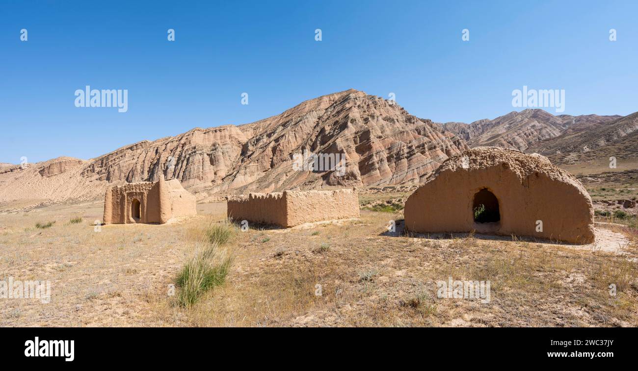 Clay mausoleums, tombs, old Kyrgyz cemetery, between dry eroded ...