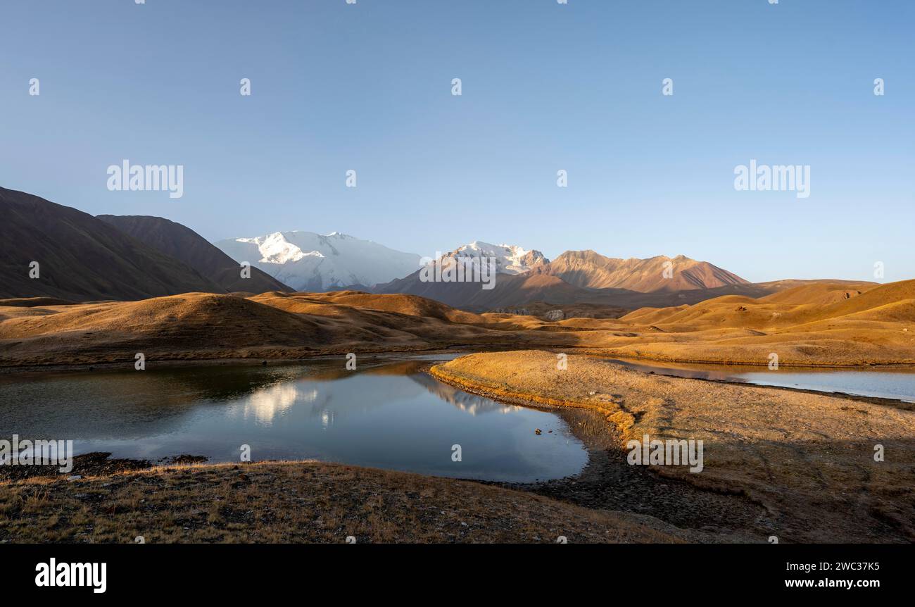 White glaciated and snowy mountain peak Pik Lenin at sunrise, mountains ...