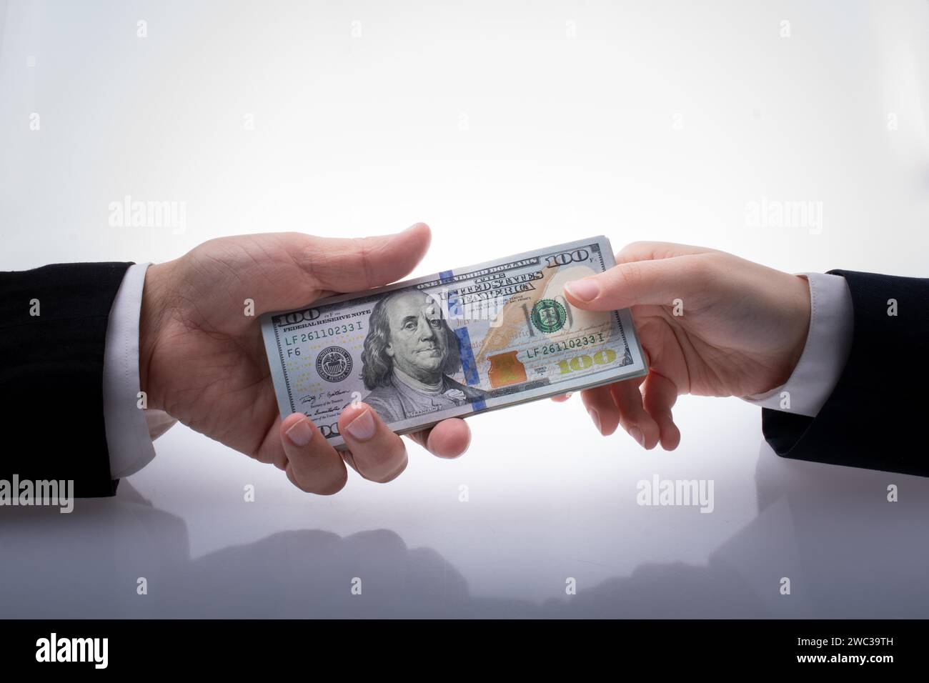 Businessman giving and receiving US dollar banknote money Stock Photo ...