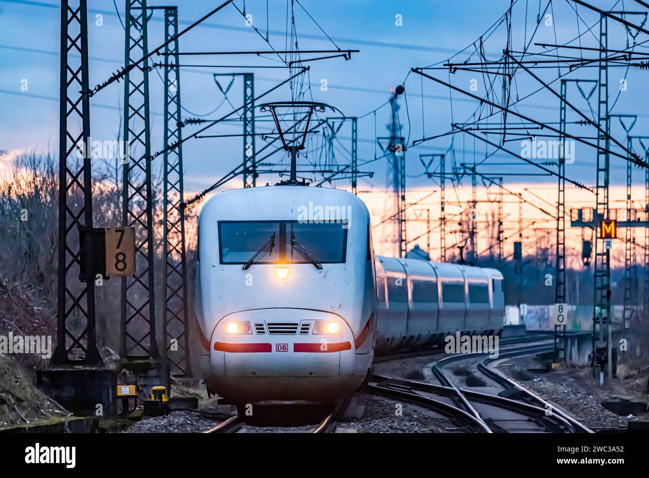 Railway line with many overhead lines and railway signals ...
