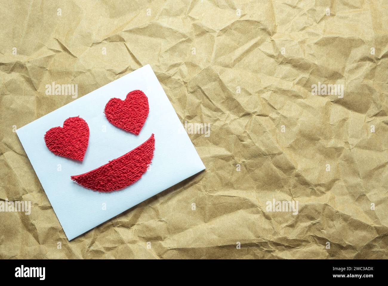 Letter with a smiley face and heart eyes Stock Photo - Alamy