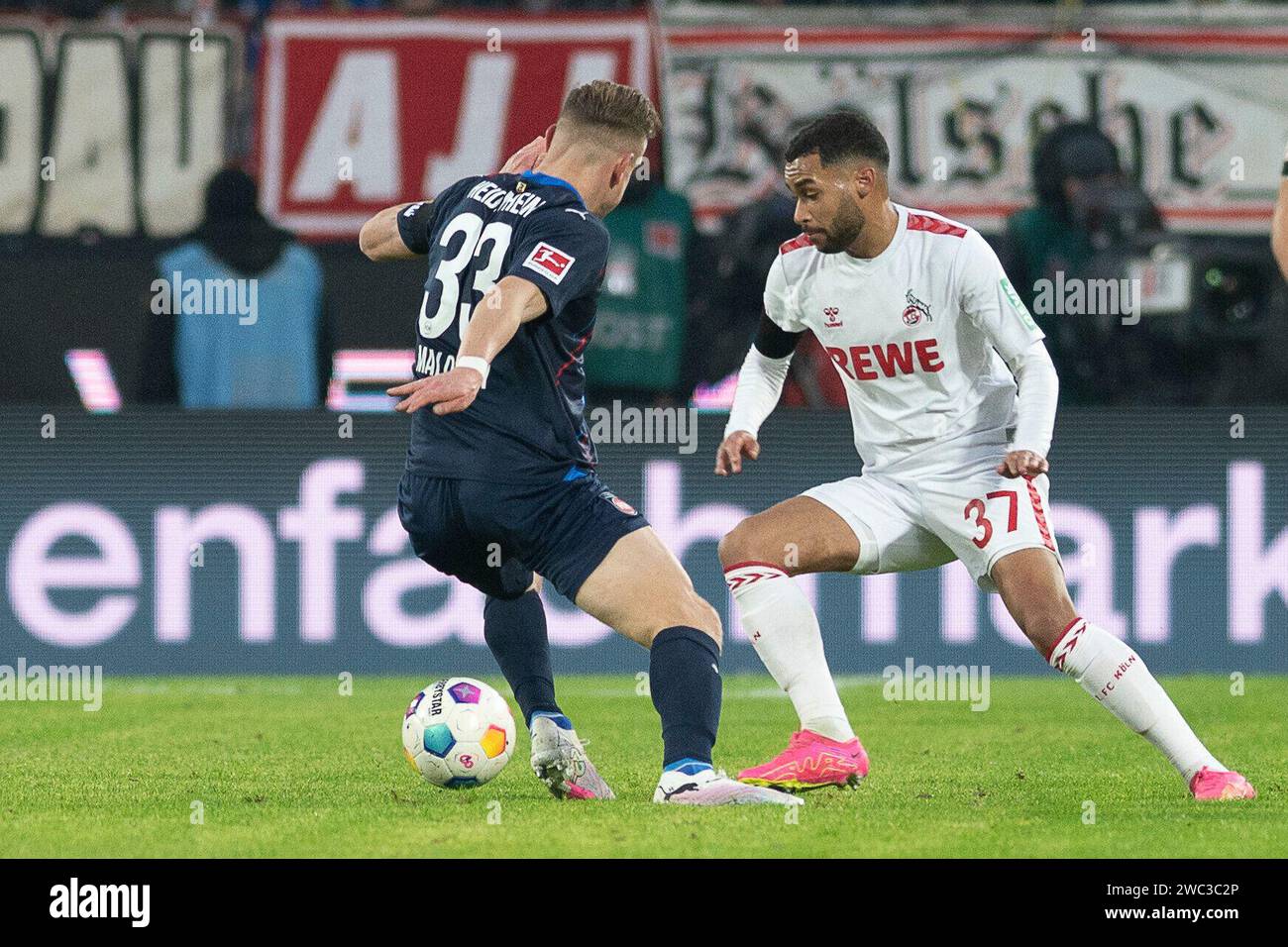 Koeln, Deutschland. 13th Jan, 2024. Linton Maina (1. FC Koeln, #37) und Lennard Maloney (FC ...