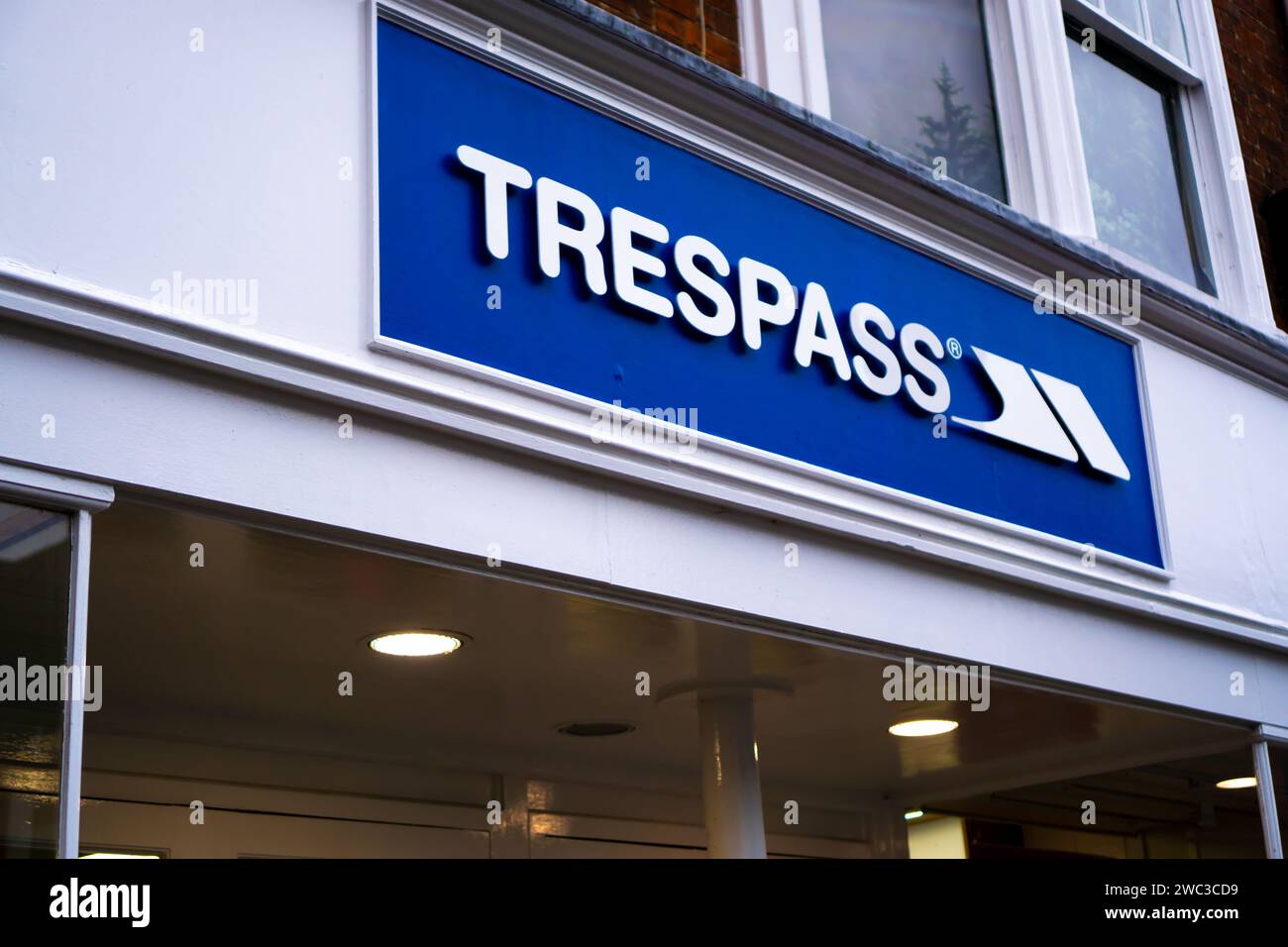 Sign above a Trespass clothes shop showing logo Stock Photo - Alamy