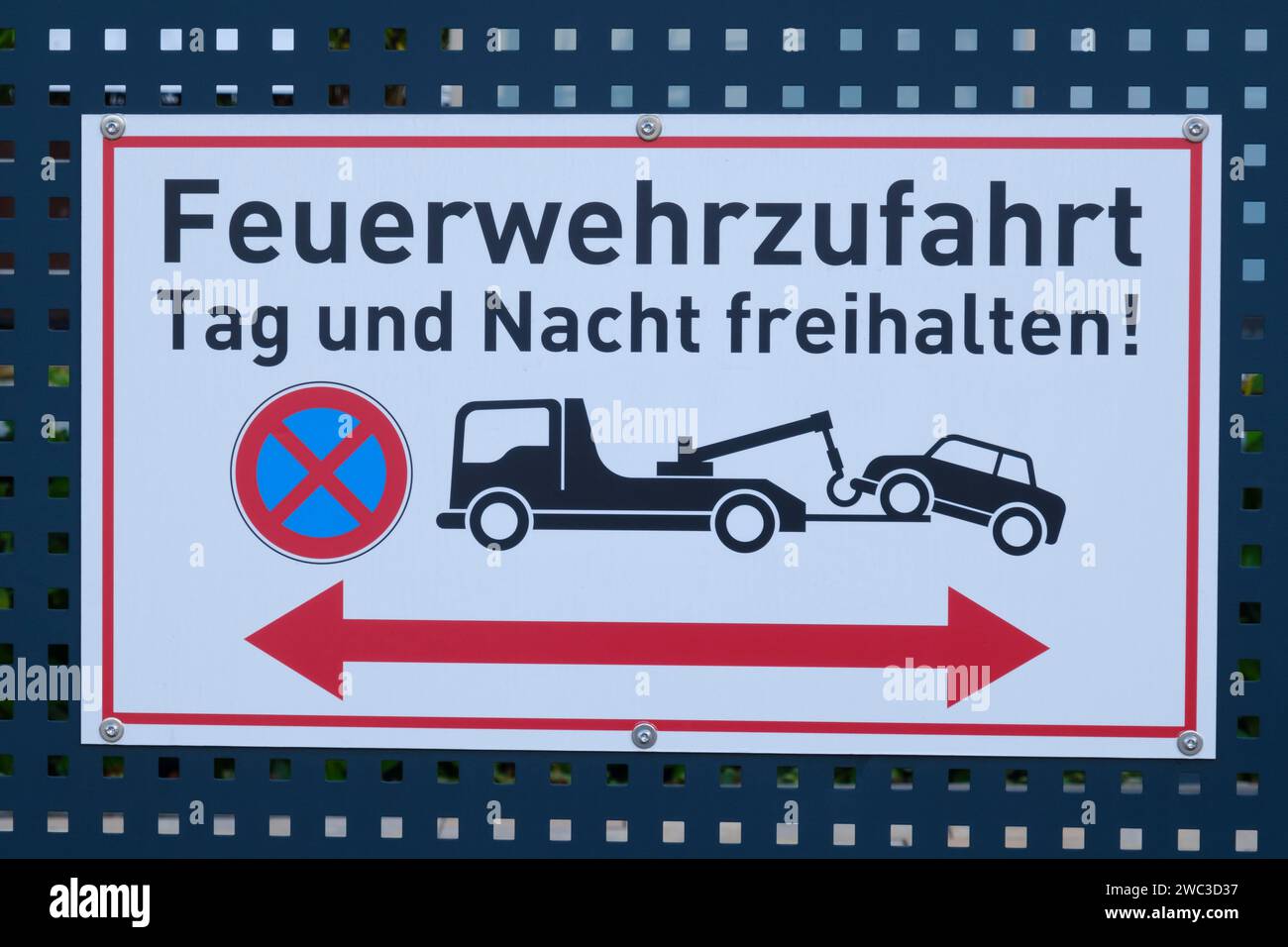 Fire brigade access road kept clear day and night, sign on a fence ...