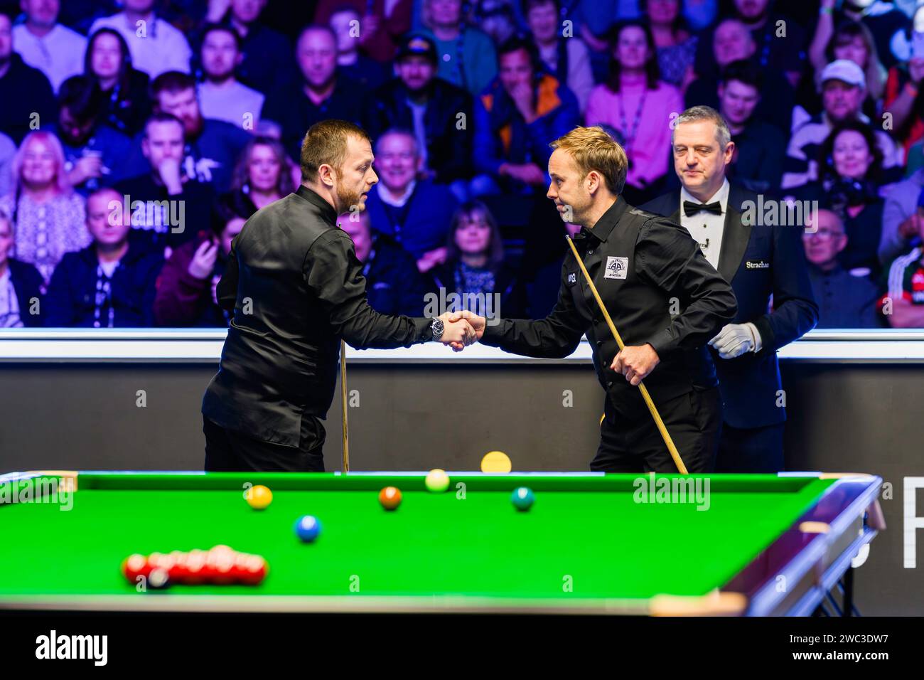 LONDON, UNITED KINGDOM. 13th Jan, 2024. Ali Carter and Mark Allen shake ...