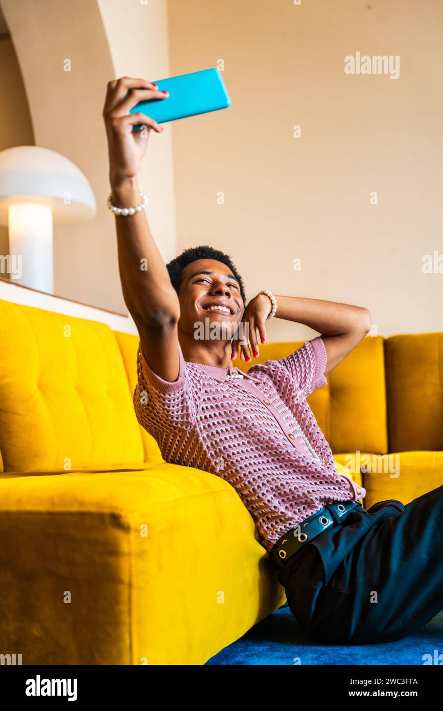 Fluid gender young man wearing cross dressing clothing at home, LGBTQ ...