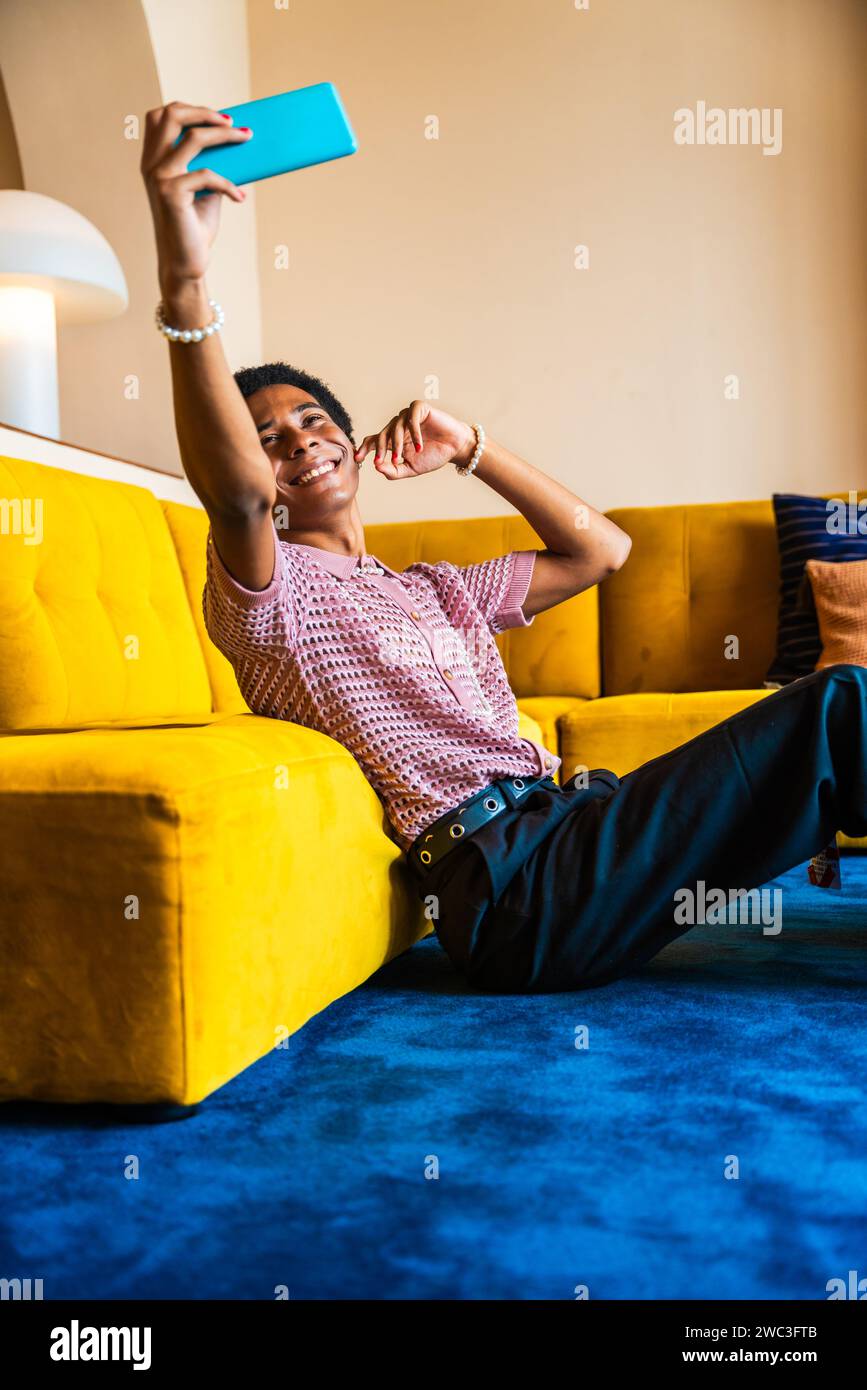 Fluid gender young man wearing cross dressing clothing at home, LGBTQ ...