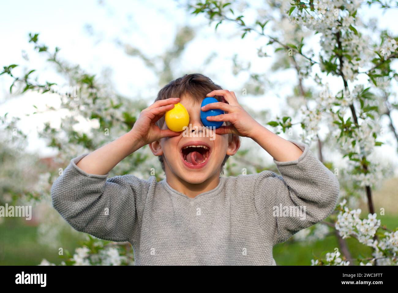 Happy easter. Cute funny preschooler boy with Easter eggs in garden ...