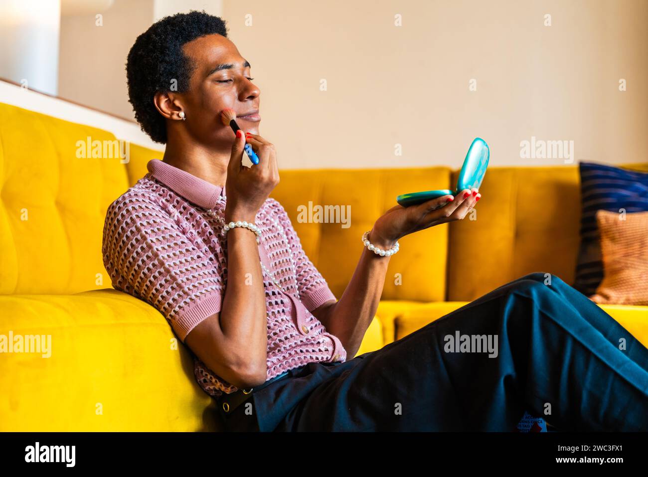 Fluid gender young man wearing cross dressing clothing at home, LGBTQ ...