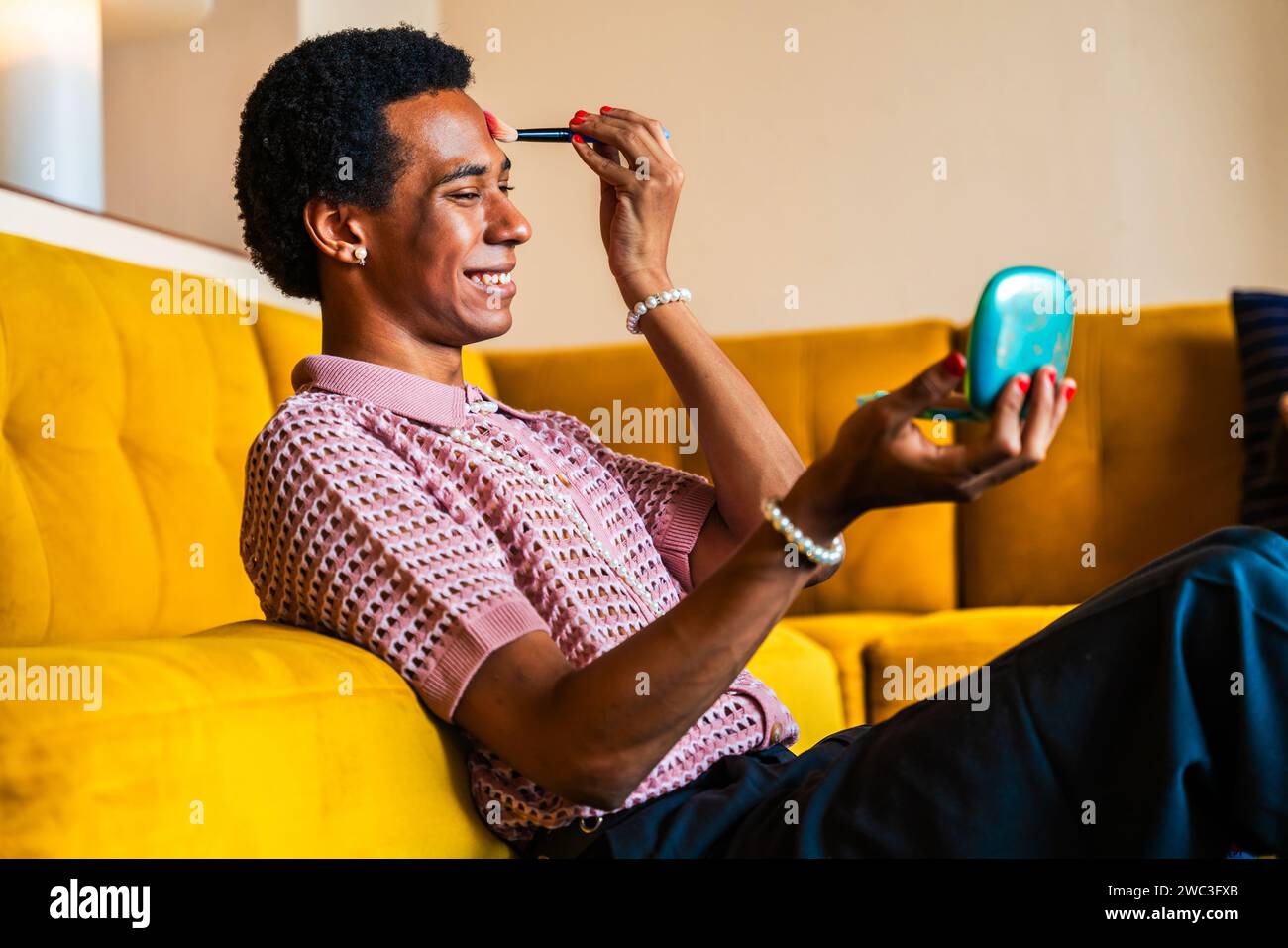 Fluid gender young man wearing cross dressing clothing at home, LGBTQ ...