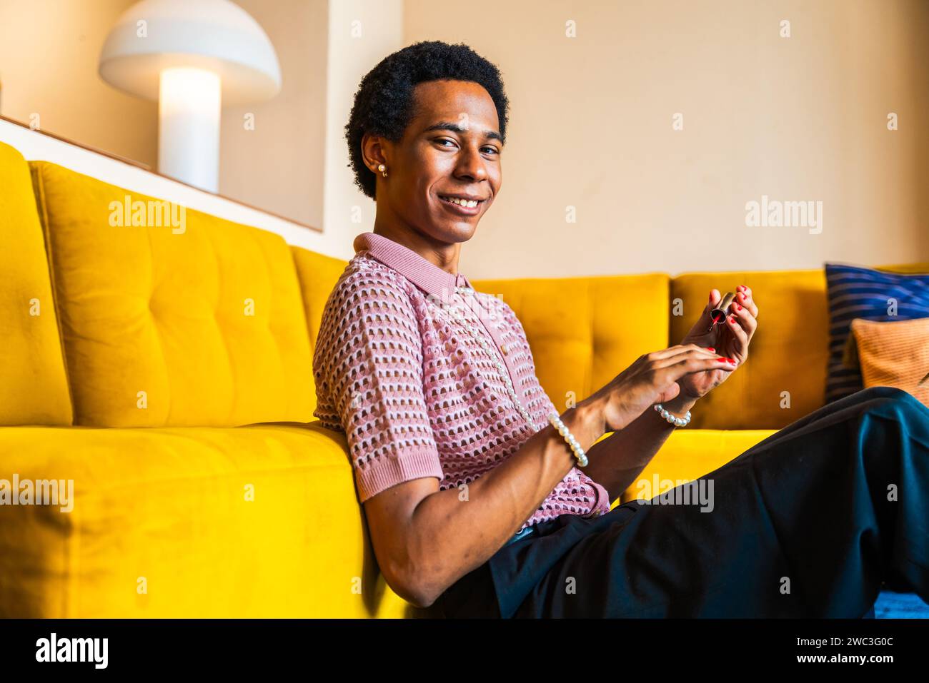 Fluid gender young man wearing cross dressing clothing at home, LGBTQ ...