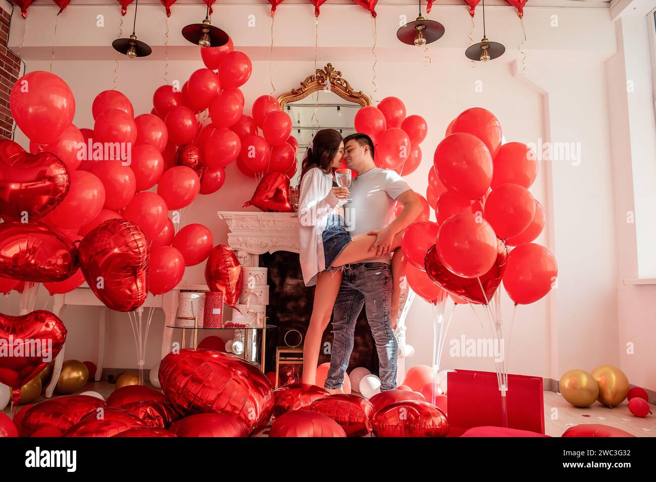 Joyous moment between dancing young couple celebrating with toast ...