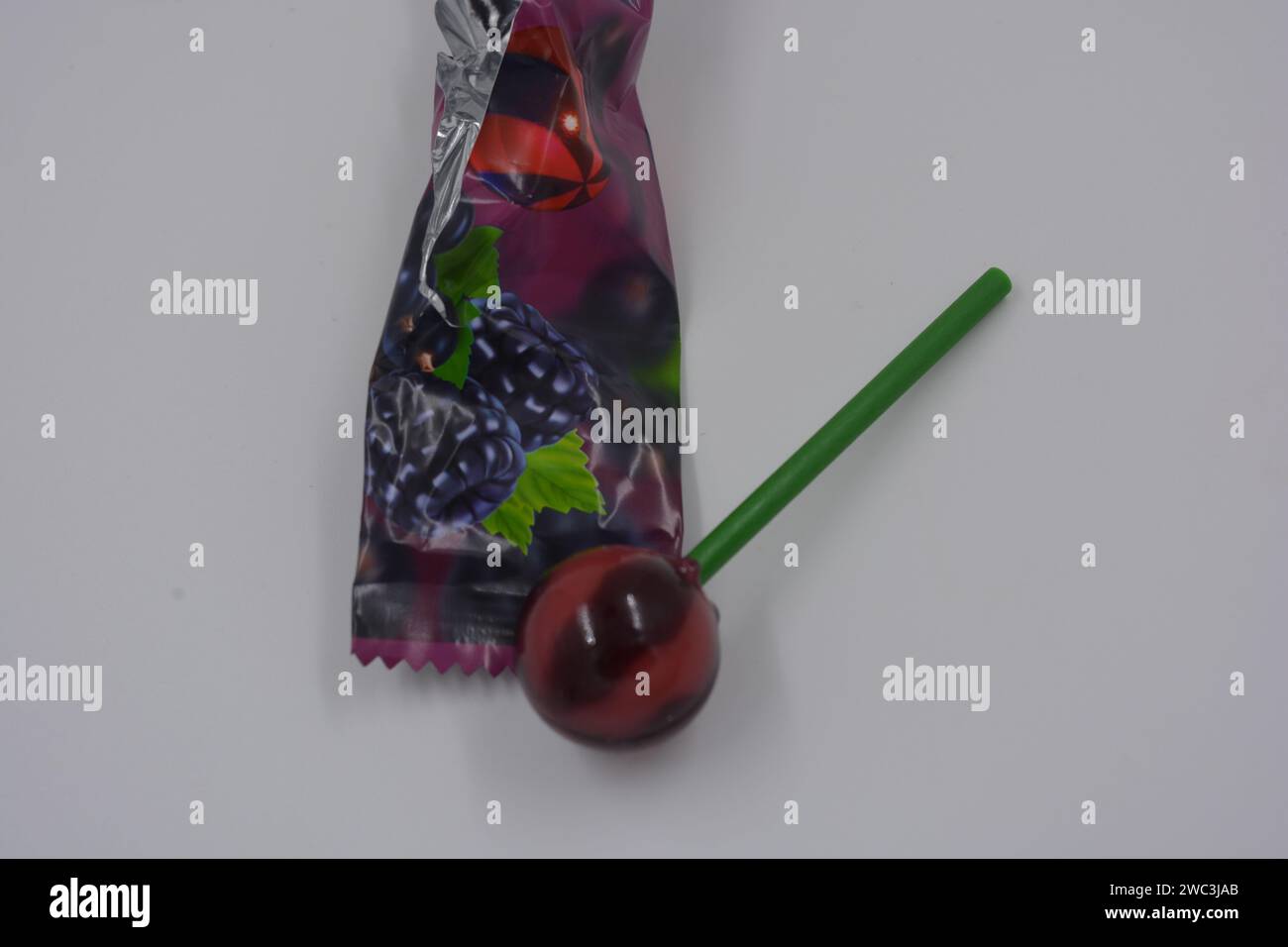 Bright natural sucking candies, lollipops on sticks in colored ...