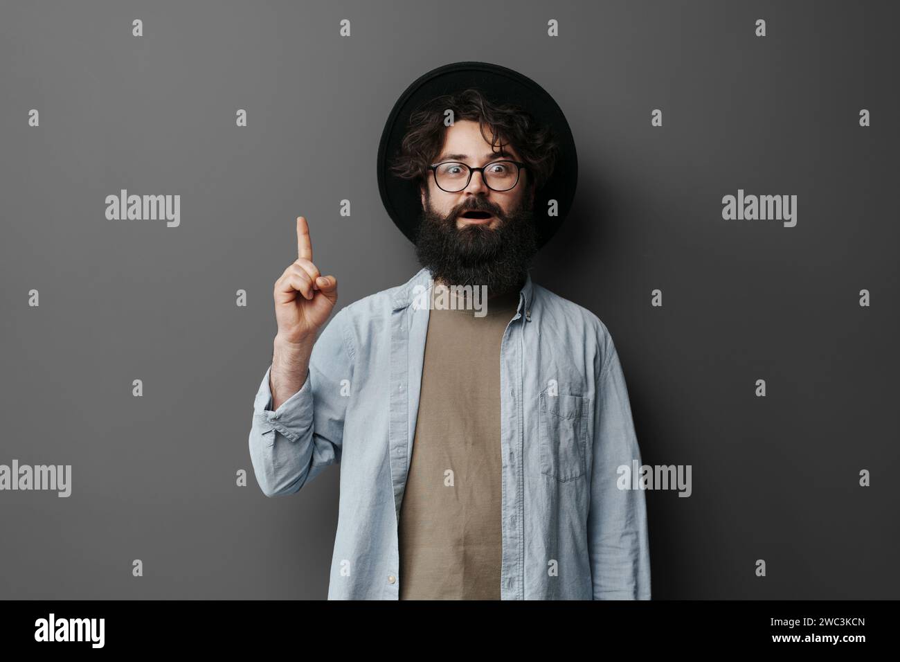 Hipster Man with Insightful Idea Pointing Upwards Stock Photo - Alamy