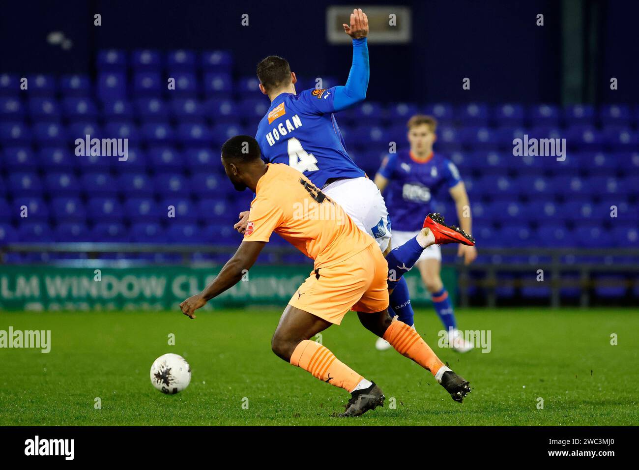 Liam Hogan of Oldham Athletic Association Football Club is tussling ...