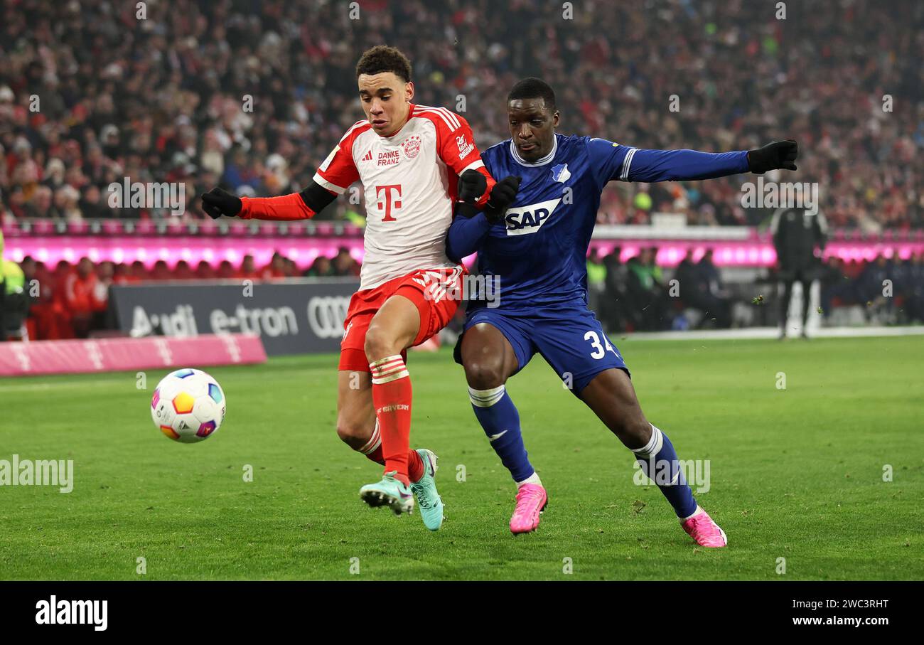 Jamal Musiala of Bayern Muenchen Stanley Nsoki of TSG Hoffenheim FC ...