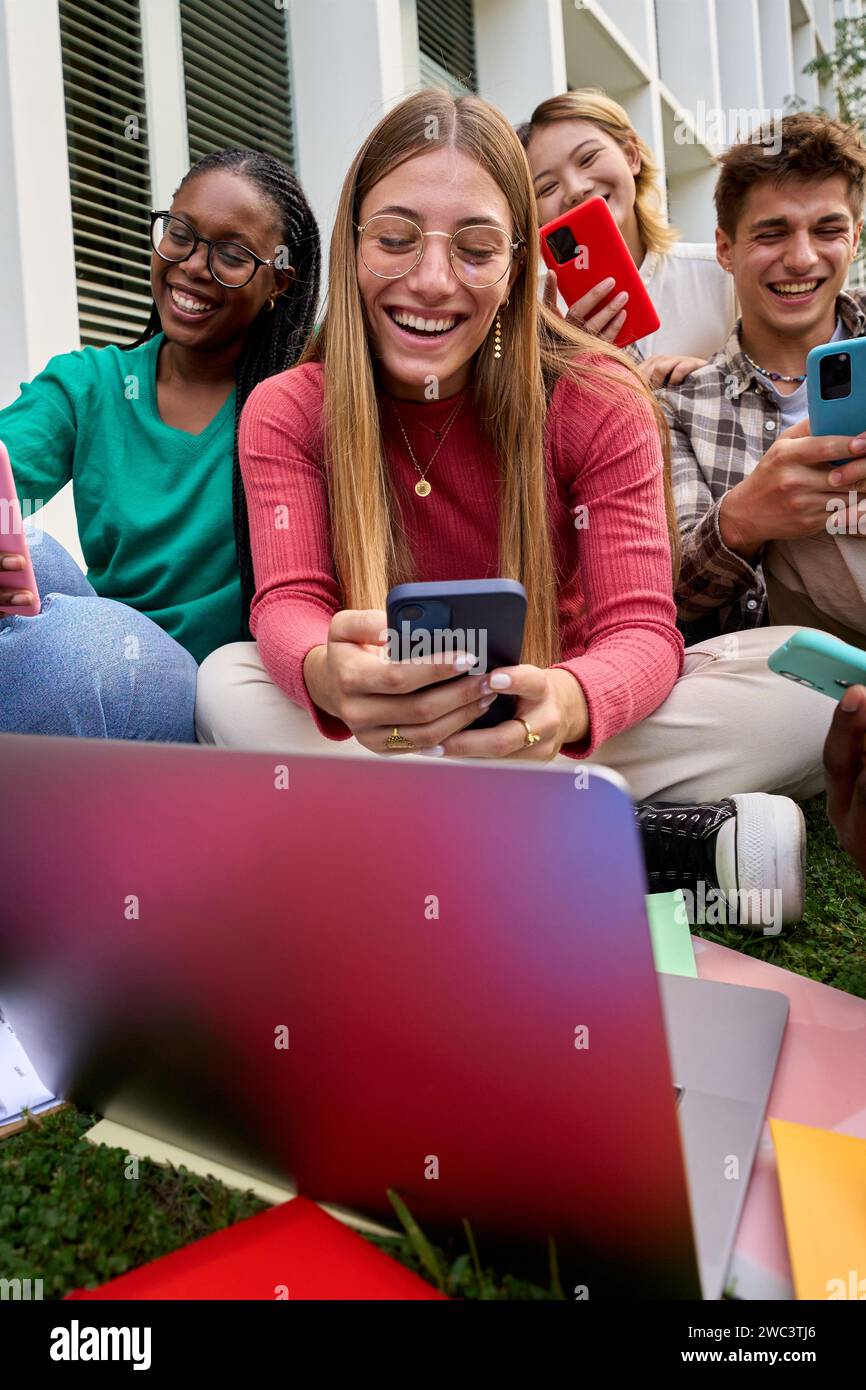 Group of young multiracial university students immersed on their mobile ...