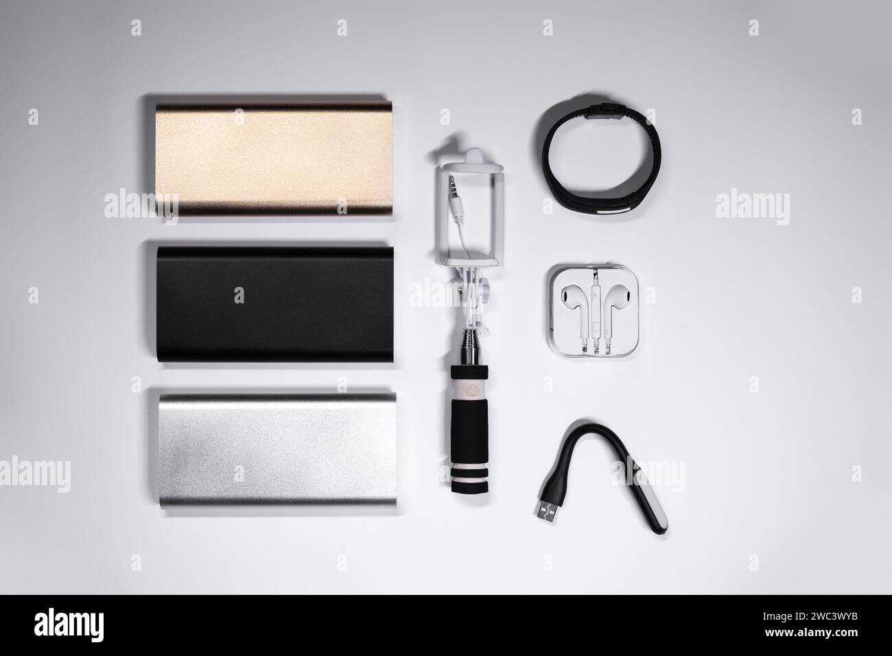 mobile power banks set with portable electronic devices on white ...