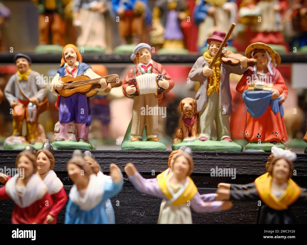 Musicians on display of Santon figurines for sale in a market booth at ...