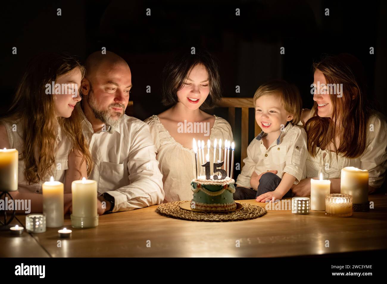 Cute Fifteen Years Old Girl Making A Wish Before Blowing Candles On Her