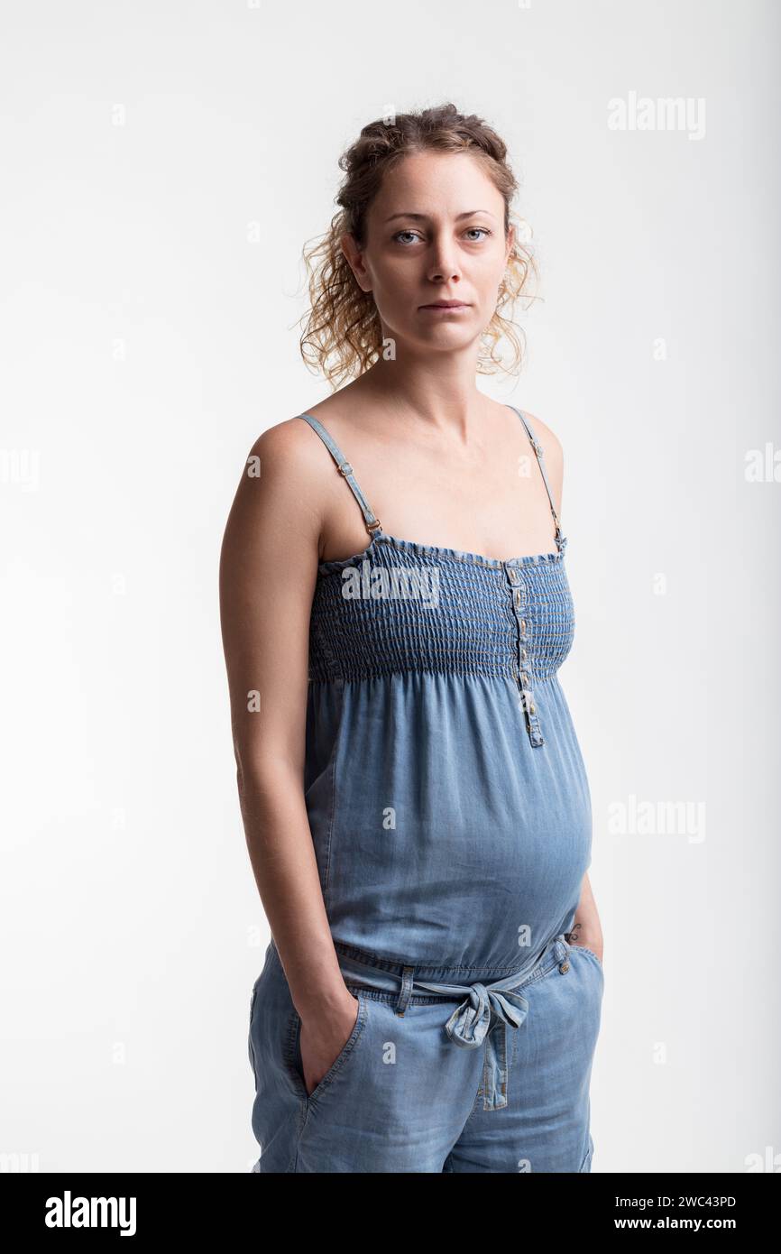 Woman in lace-trimmed shorts, revels in the late stages of pregnancy ...