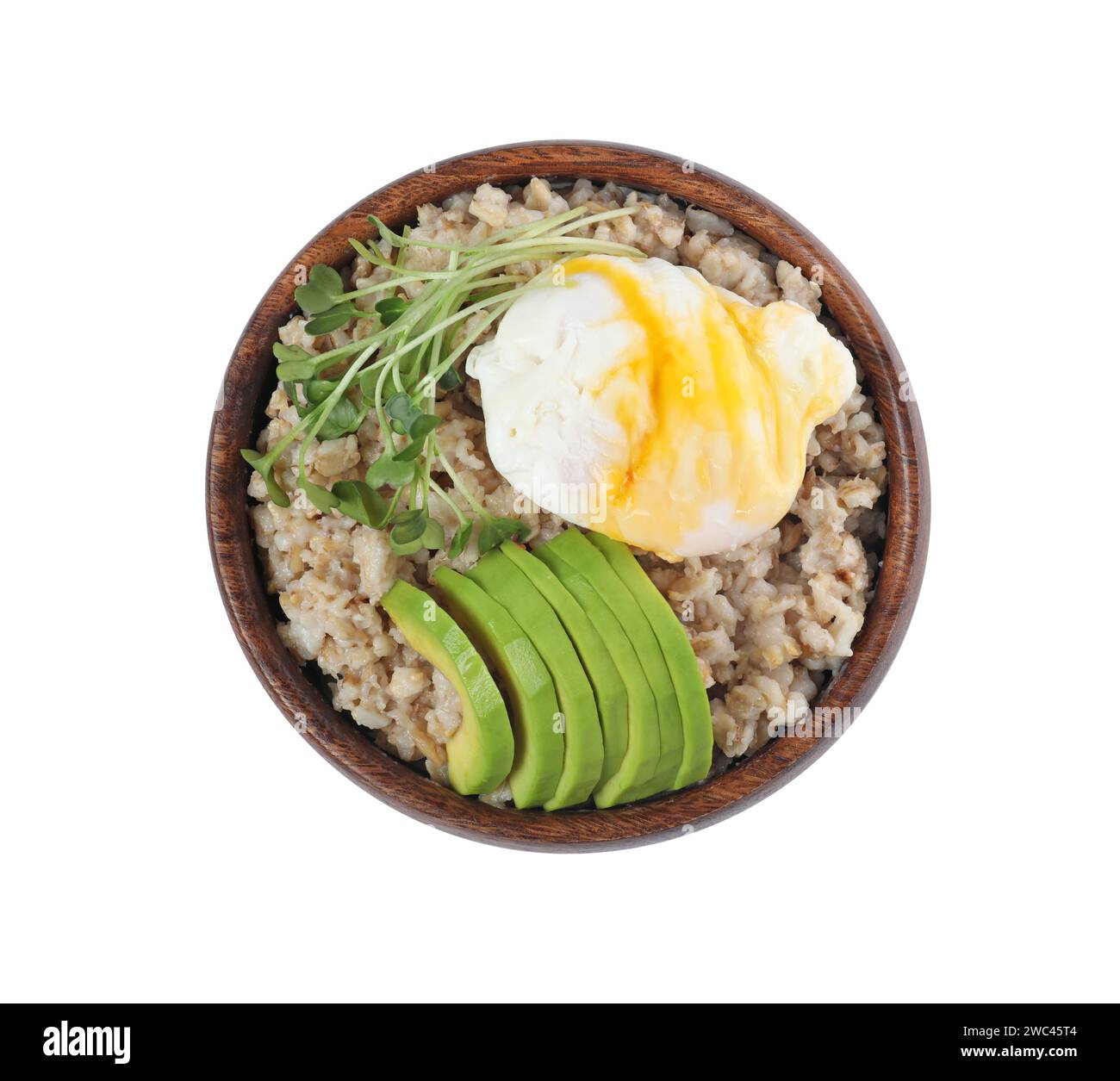 Delicious boiled oatmeal with poached egg, avocado and microgreens in ...
