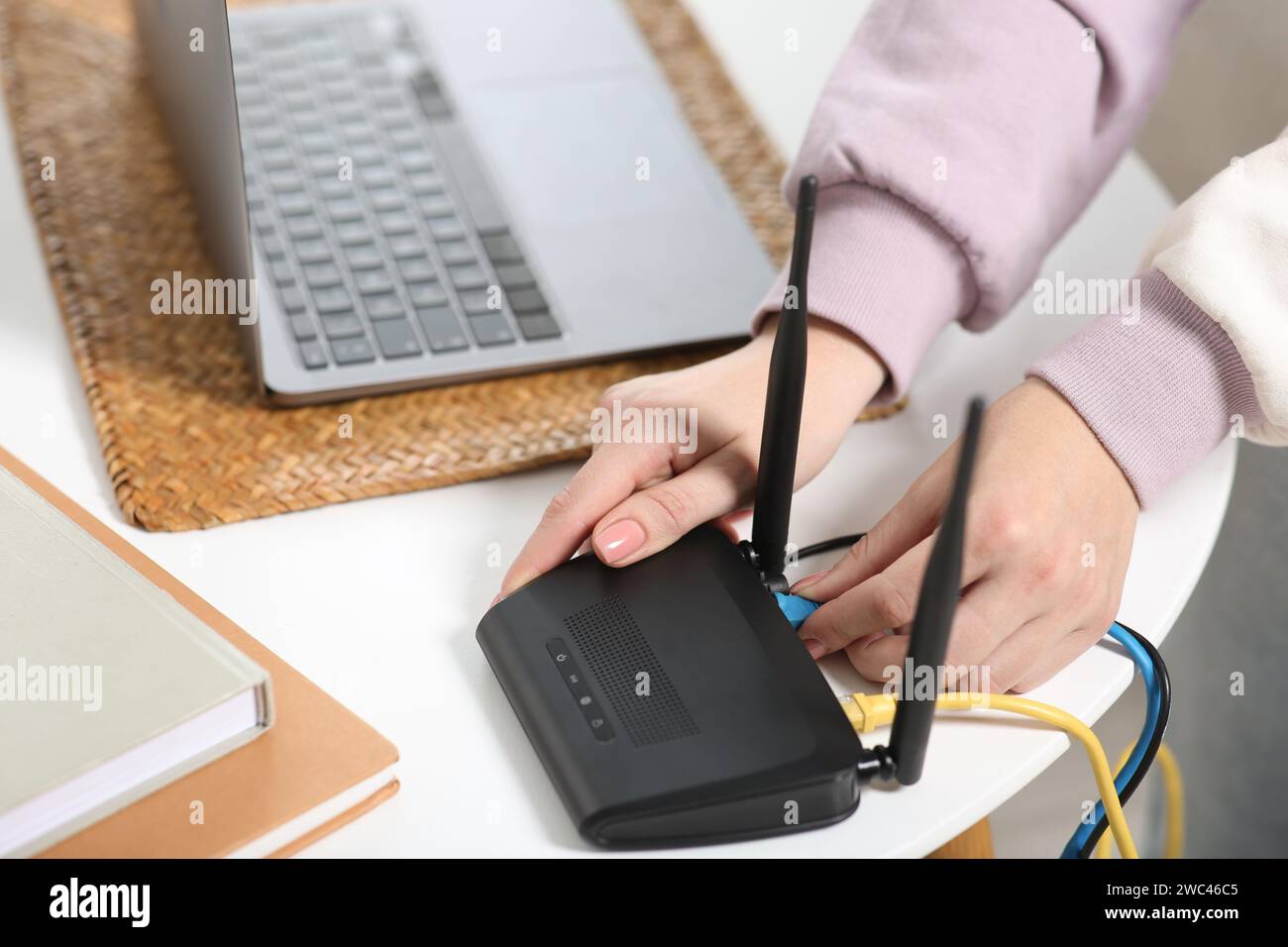 Hands ethernet cable router hi-res stock photography and images - Alamy