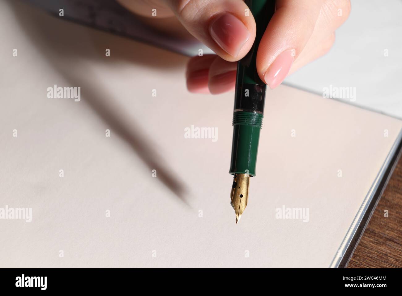 Woman writing with pen hi-res stock photography and images - Alamy