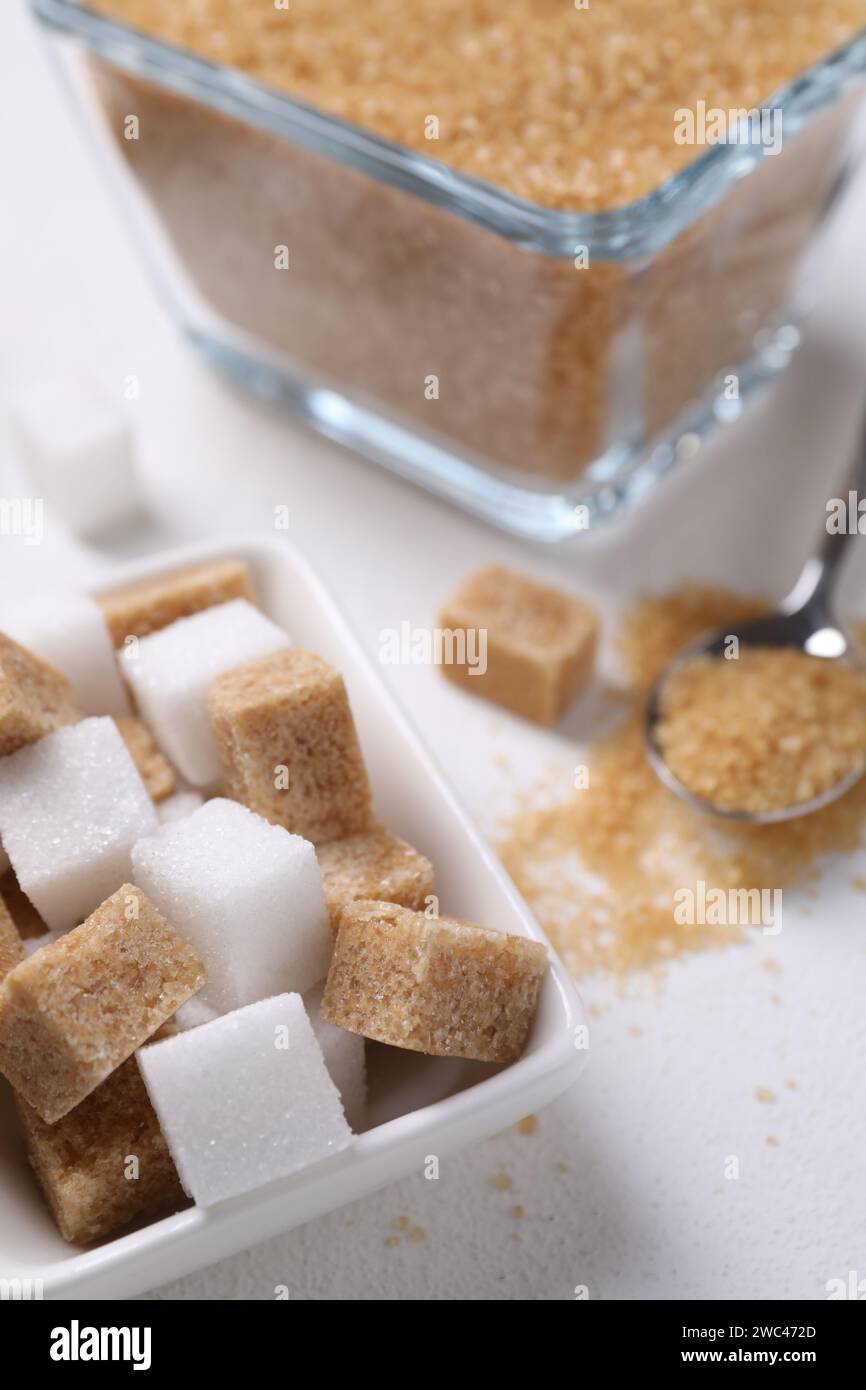 Different types of sugar in bowls on white table, closeup Stock Photo ...