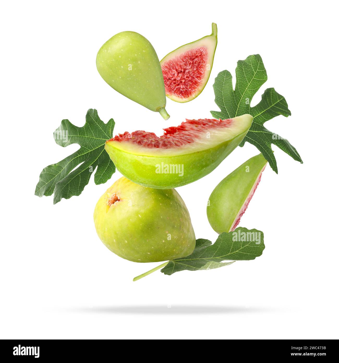 Ripe figs and green leaves falling on white background Stock Photo - Alamy