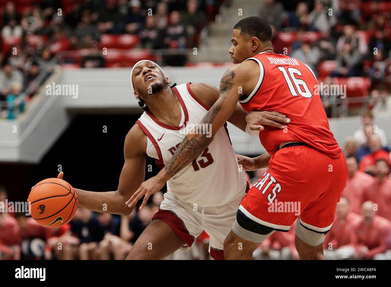 Washington State forward Isaac Jones (13) drives while pressured by Arizona forward Keshad ...