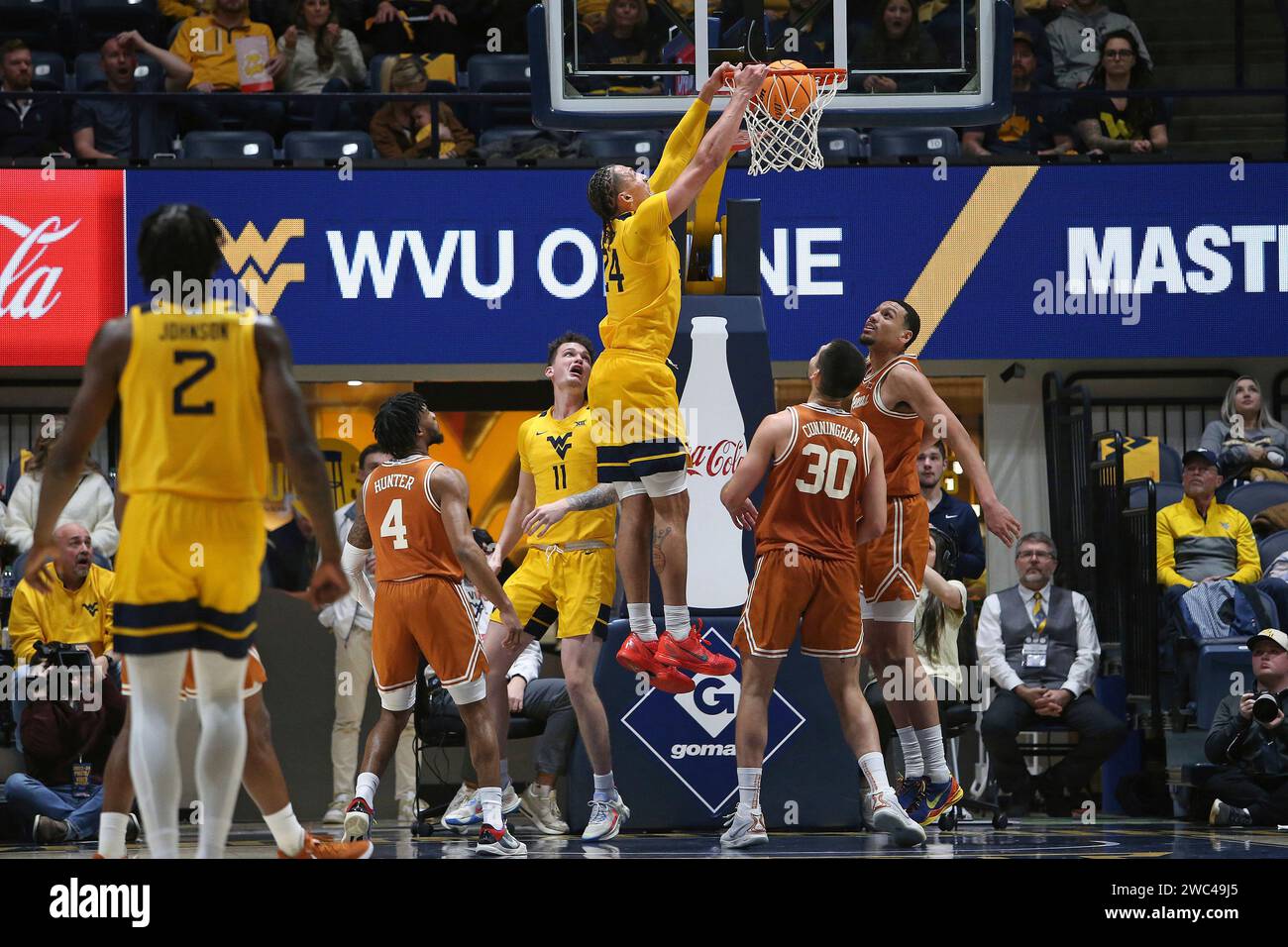 West Virginia forward Patrick Suemnick (24) dunks against Texas during ...