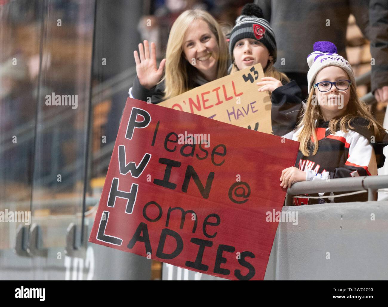 Young fans hold signs prior to Montreal's PWHL home-opener hockey game ...