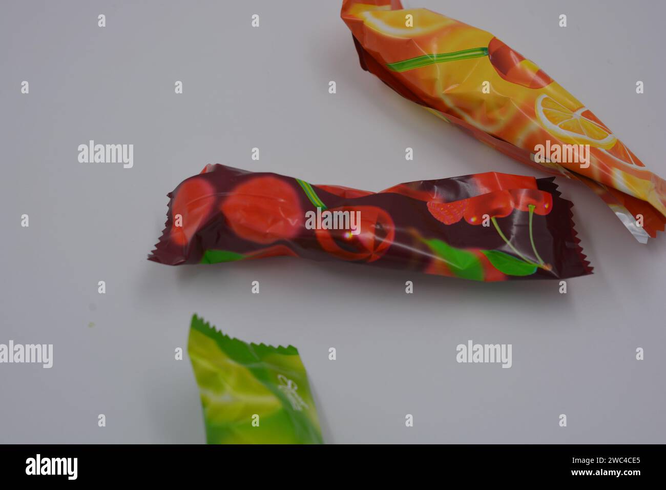 Bright natural sucking candies, lollipops on sticks in colored ...