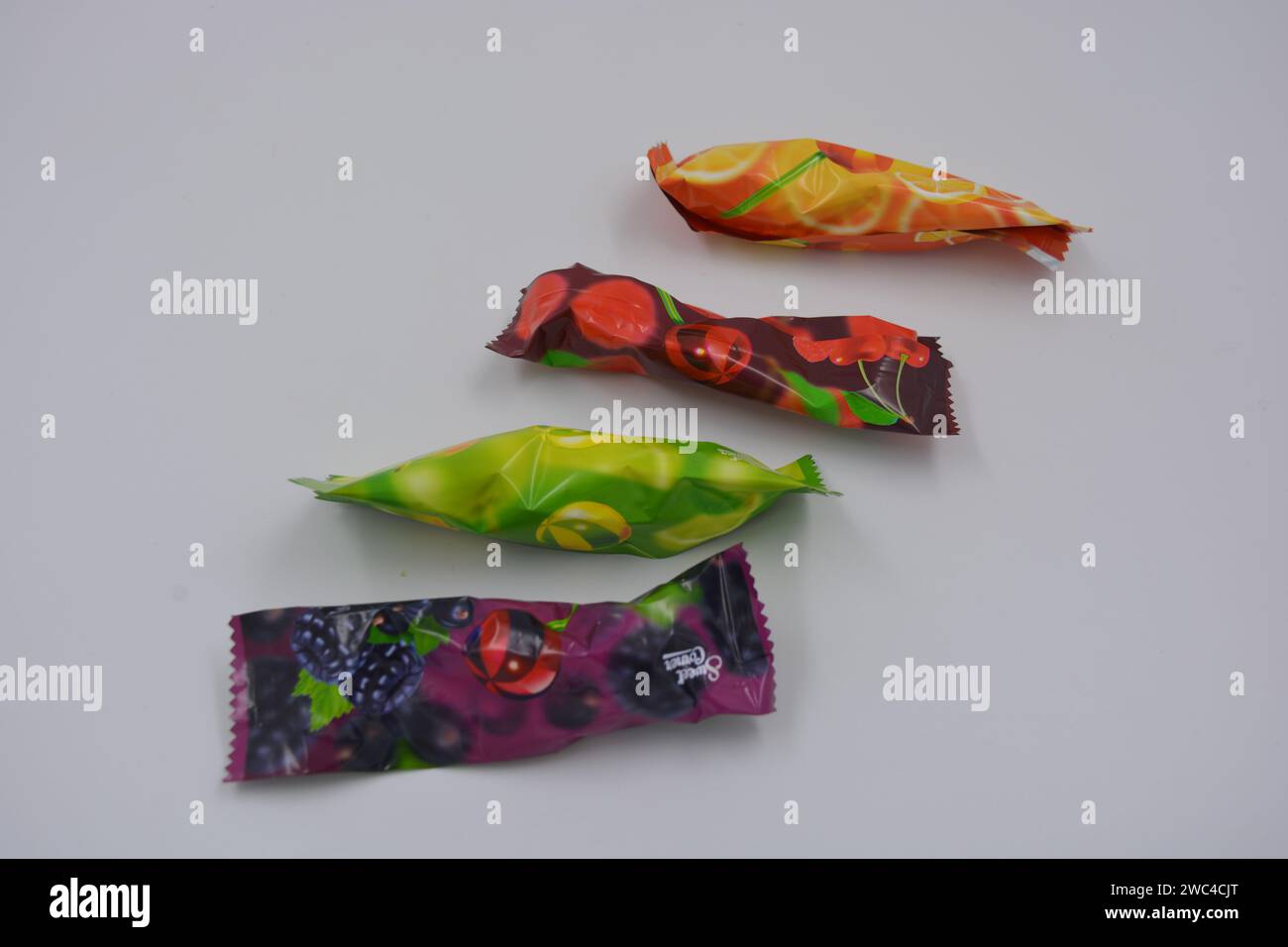 Bright natural sucking candies, lollipops on sticks in colored ...