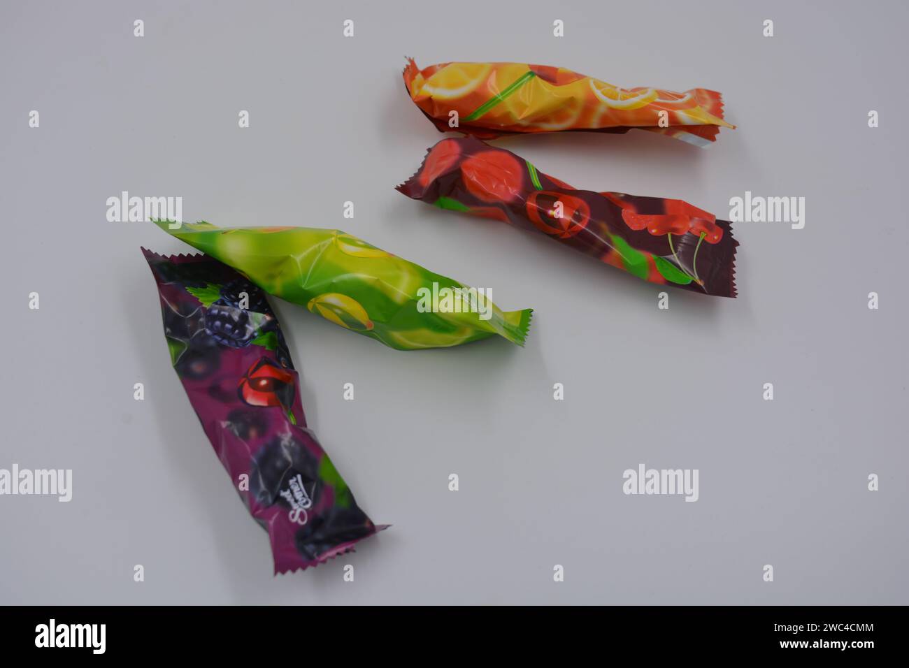 Bright natural sucking candies, lollipops on sticks in colored ...