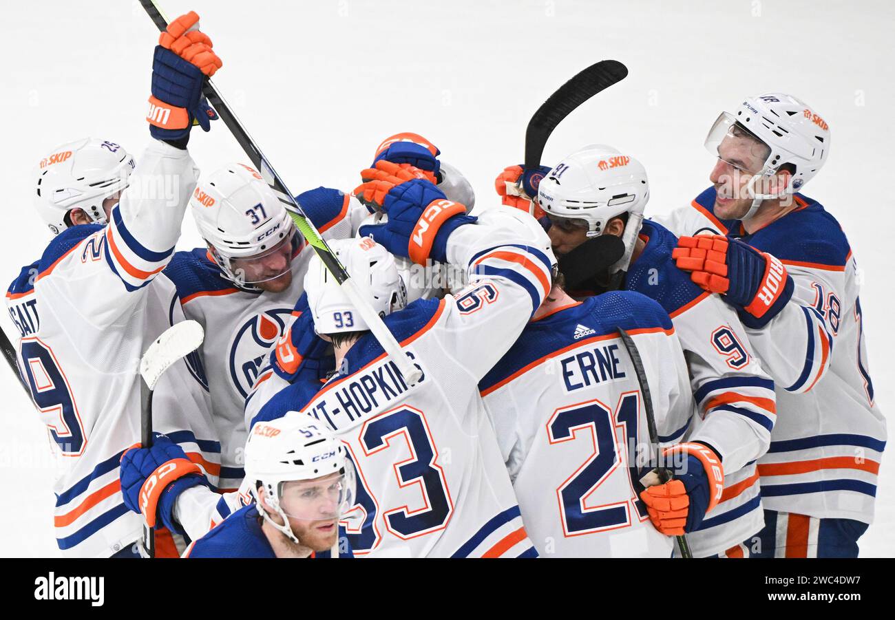 Edmonton Oilers players celebrate a goal by teammate Evan Bouchard ...