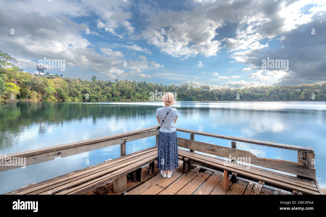 Lake Yeak Laom, Krong Ban Lung, Cambodia-December 29, 2023: Female tourist takes a selfie by ...