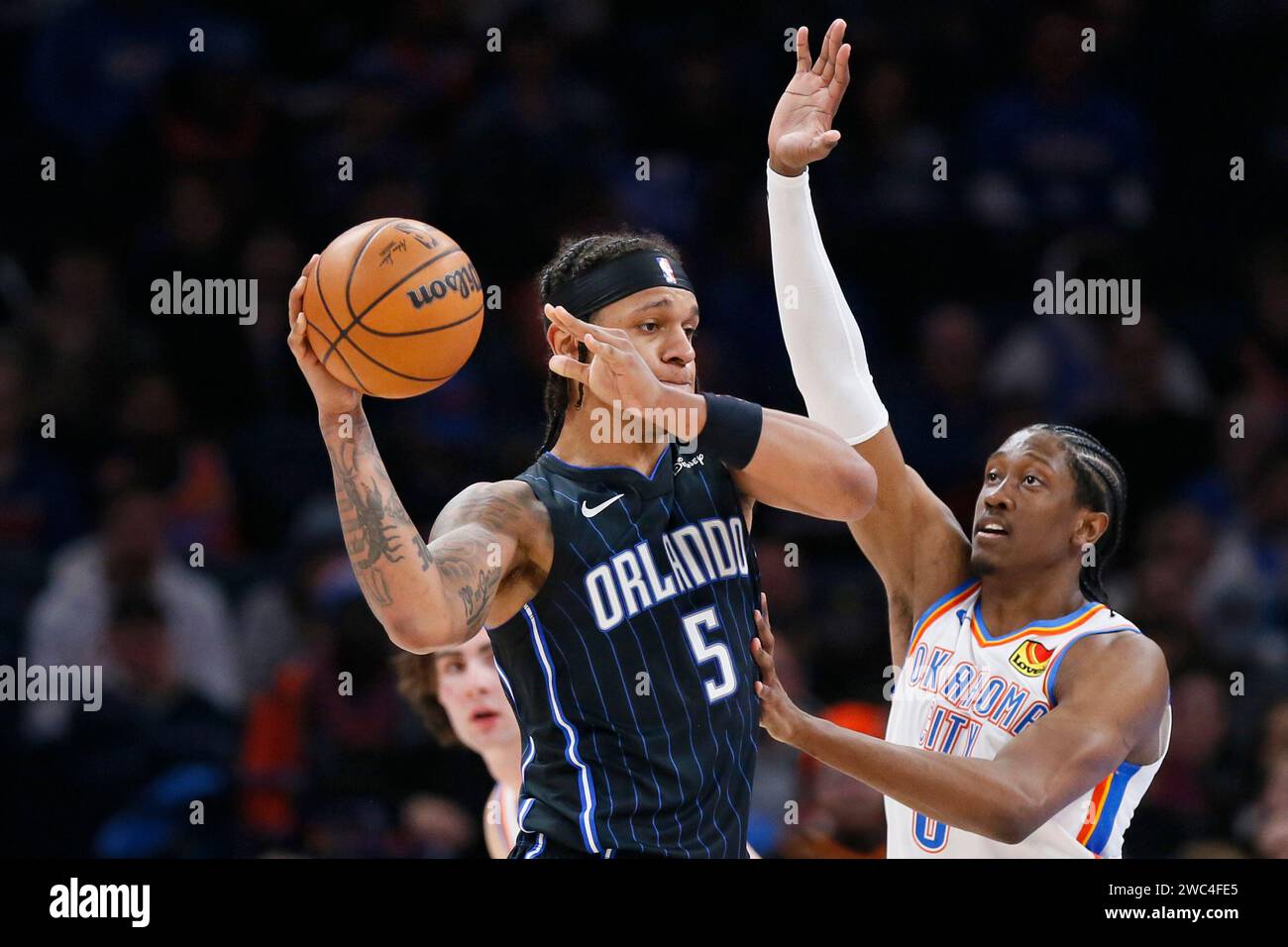 Orlando Magic forward Paolo Banchero (5) looks to pass the ball as Oklahoma City Thunder forward ...