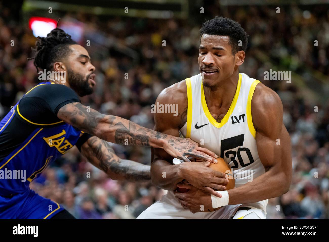 Utah Jazz guard Ochai Agbaji, right, defends his rebound from Los ...