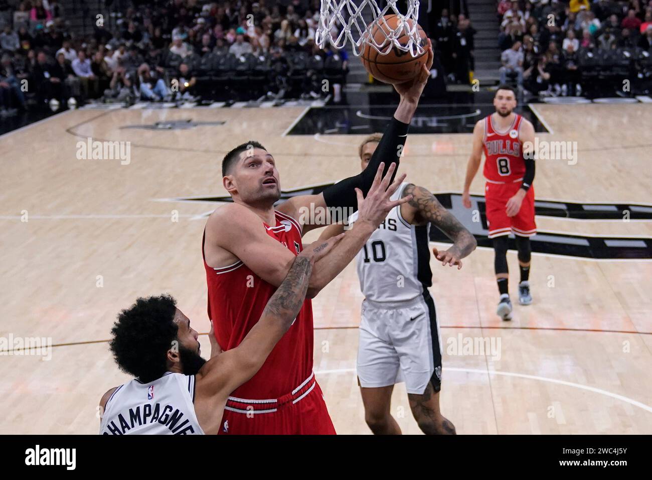 Chicago Bulls center Nikola Vucevic, center, shoots over San Antonio ...