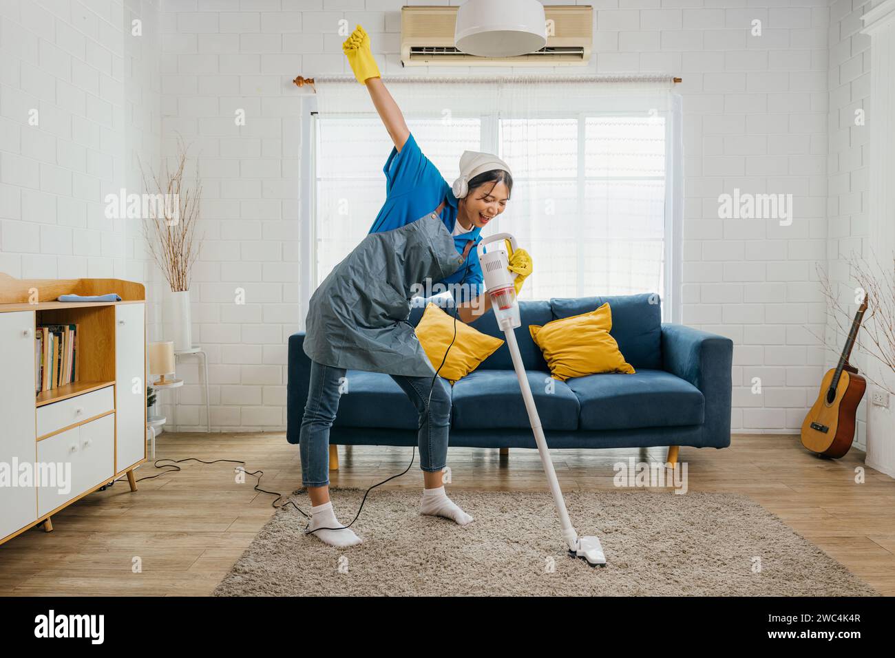 House cleaning turns joyful Asian housewife happily sings using a ...