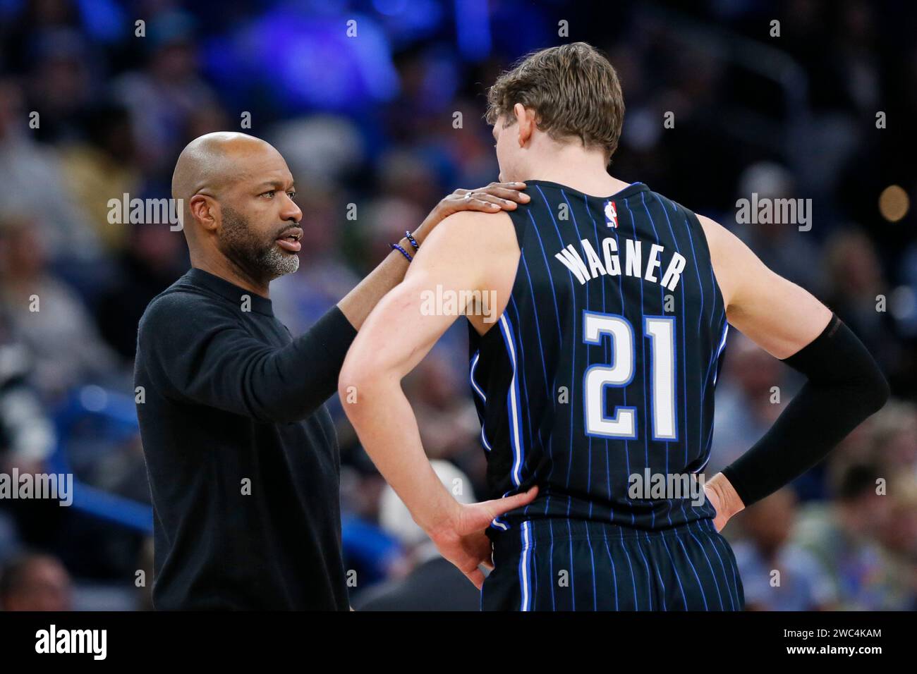Orlando Magic coach Jamahl Mosley, left, talks to center Moritz Wagner ...