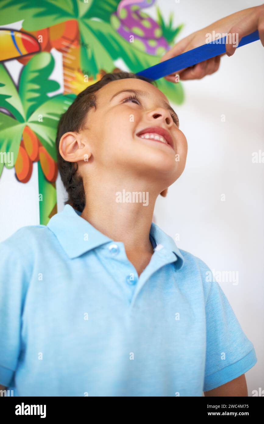 Smile, kid and hands measure height, check future increase in growth of ...