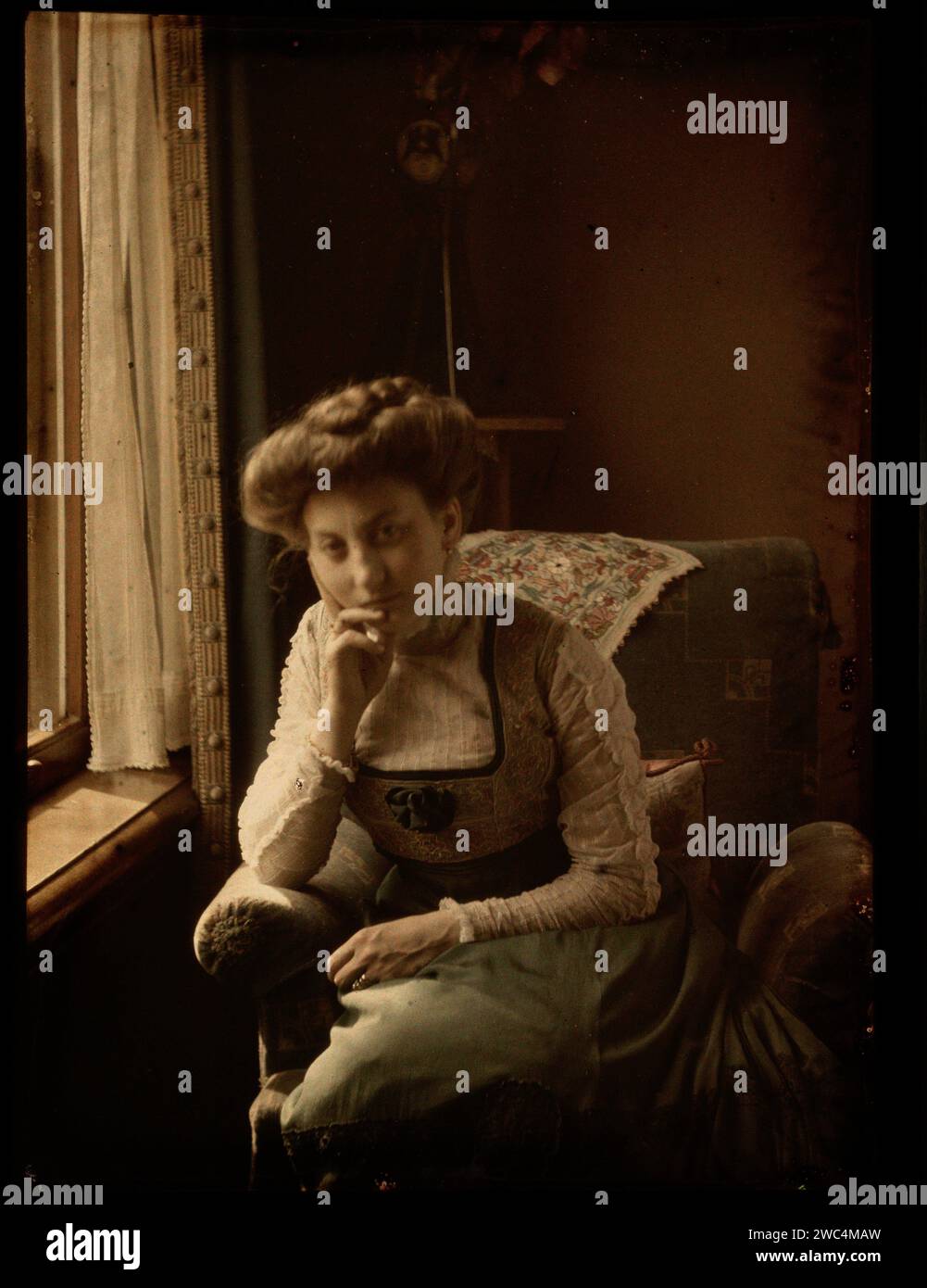 Woman sitting by the window, 1907 - 1916 photograph Interior with young ...