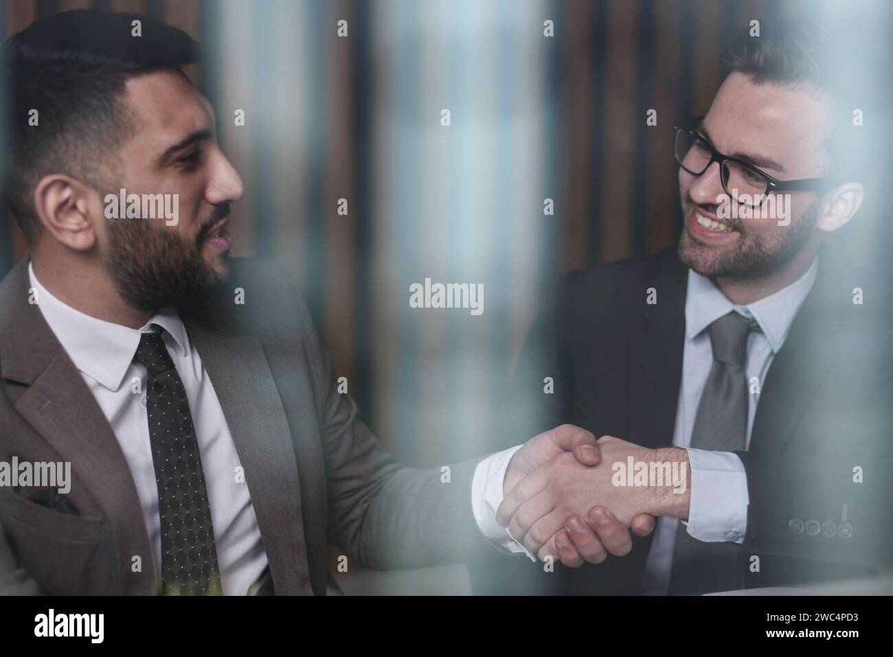 Two happy people make a good business deal and exchange confident ...