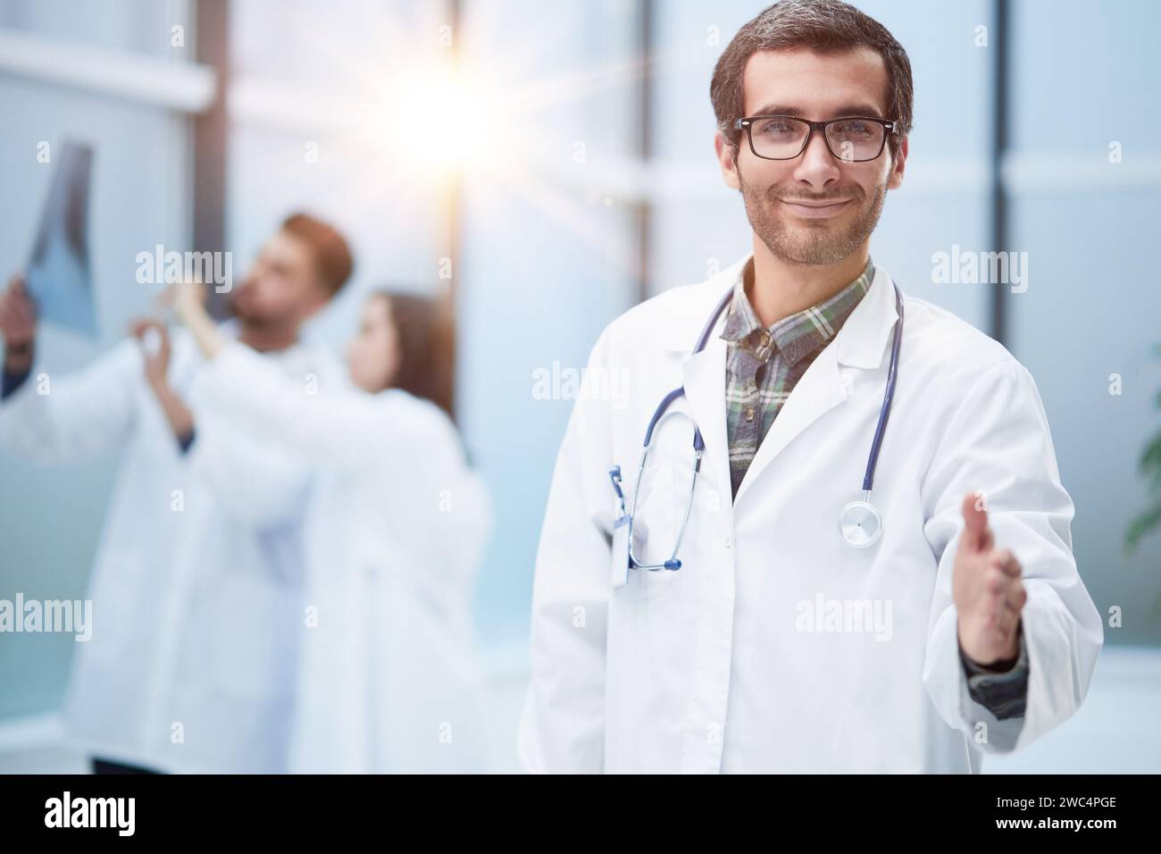 image of the doctor holding out his hand for greeting Stock Photo - Alamy