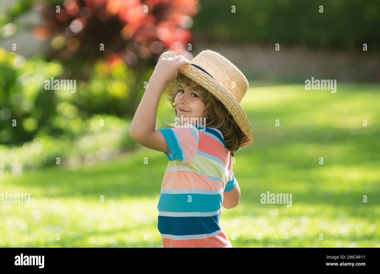 Portrait of a cute summer child boy in summer nature park. Close up ...